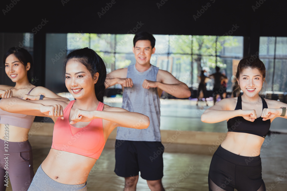 A group of young beautiful Asian women exercise in the fitness gym by ...