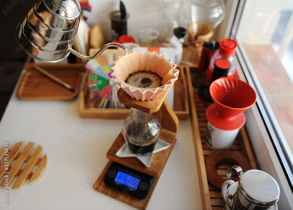 Pink ceramic origami dripper on wooden drip station on scale. Manual ...