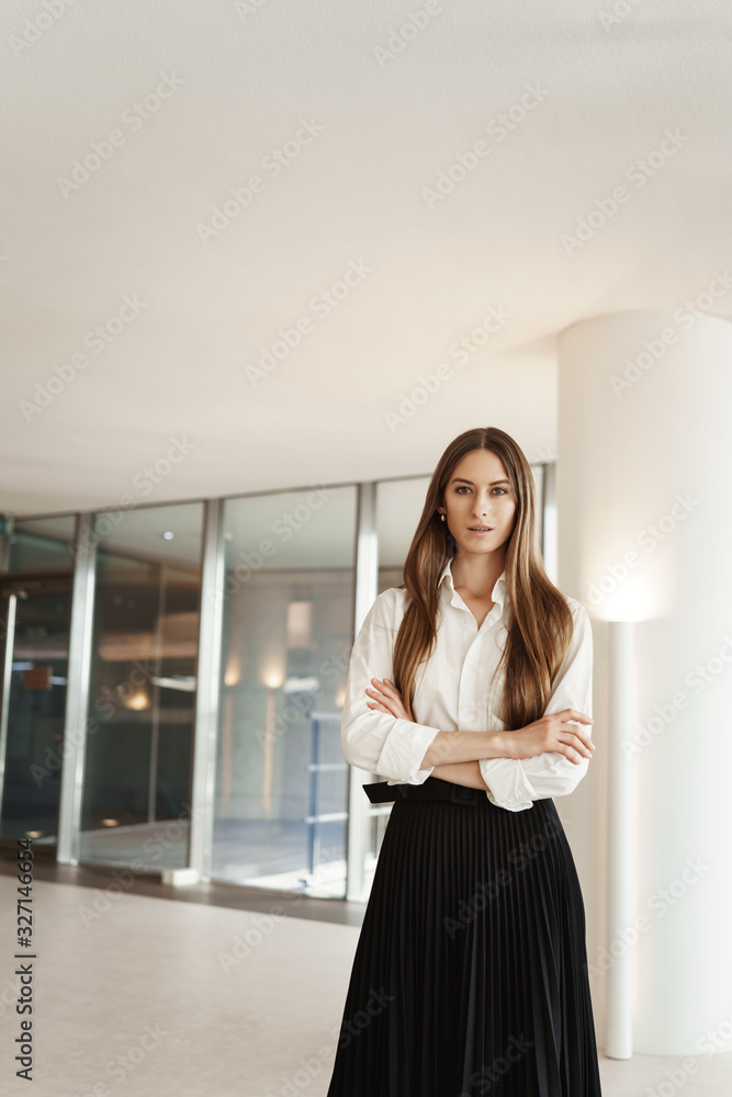 Feminine strong and confident woman in long black skirt and white ...