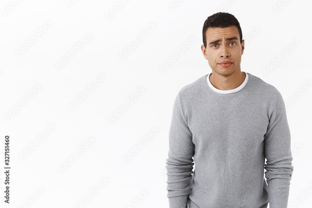 Skeptical and unamused good-looking young man, listening strange ...