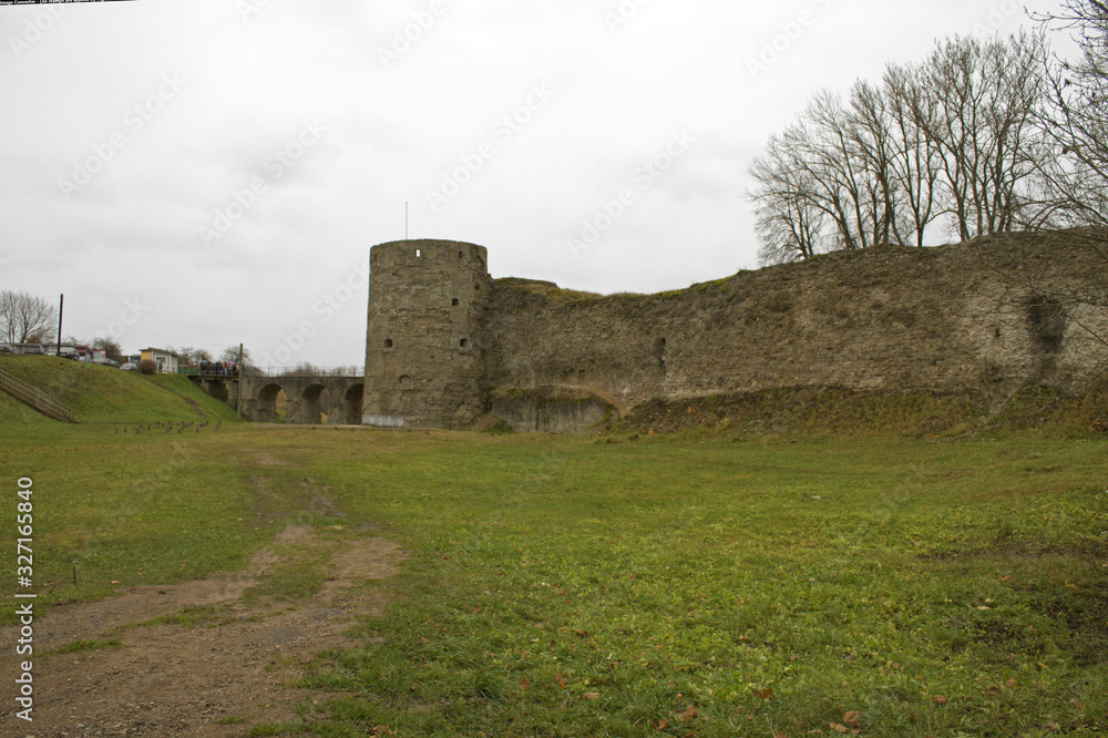 The defensive wall of a medieval castle with a bridge and towers ...