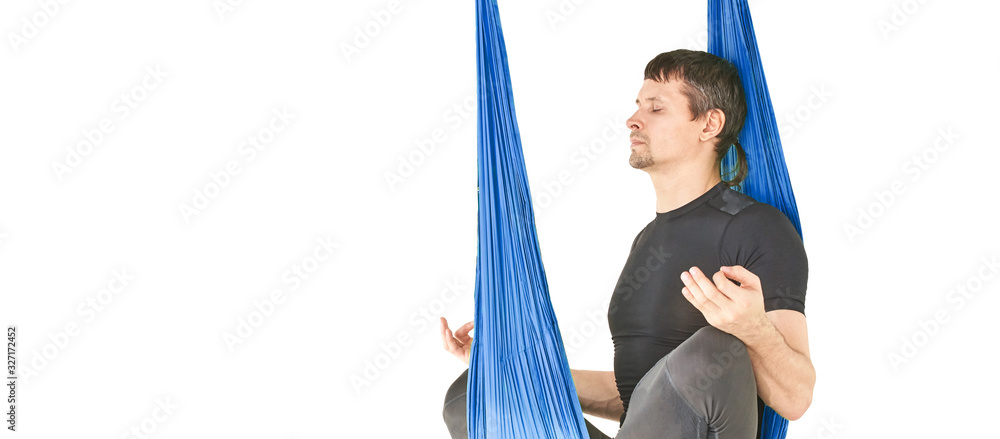 Male person do hammock yoga class exercise. Meditation in air clam ...