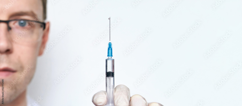 Male person in white glove hold vaccine bottle with syringe. Injection ...