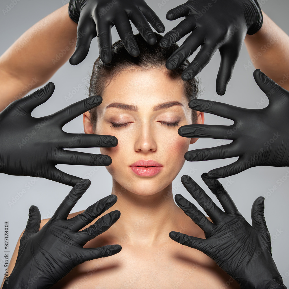 Face skin check before plastic surgery. Medical doctors are checking a ...