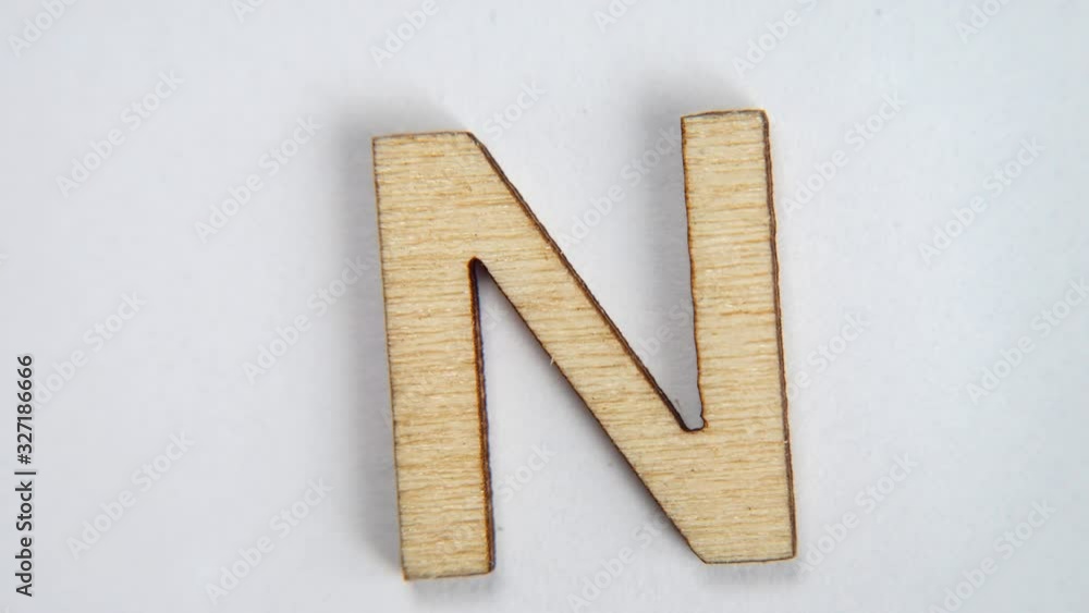 Wooden letter N of the English alphabet in motion. Letter moves on a ...