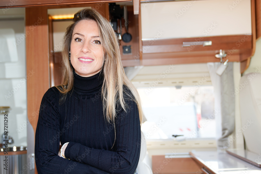 beautiful young woman in modern motorhome campervan during road trip ...
