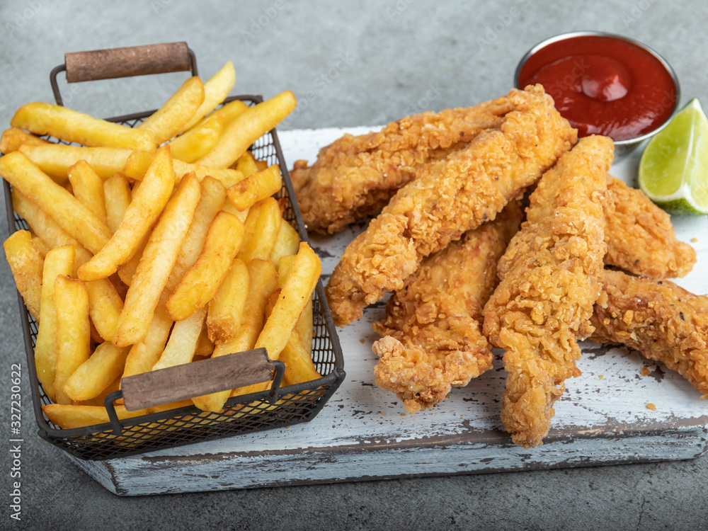 crispy fried breaded chicken breast strips french fries and sauce Stock ...