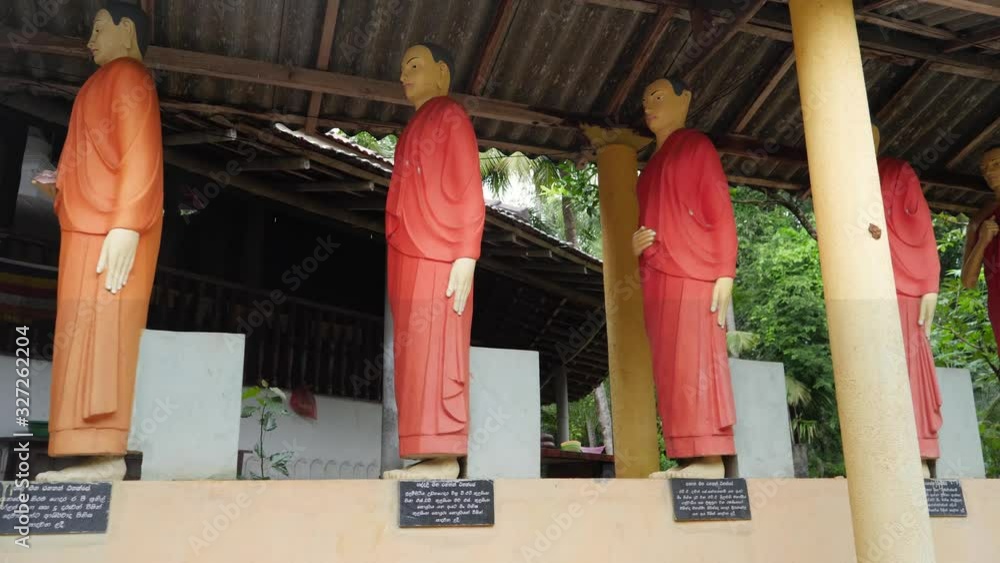 4k dolly video of buddhist monks statues standing in row at the ...