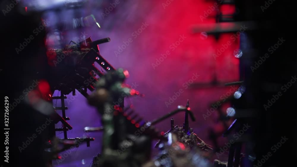 Army sniper with large caliber rifle standing in the fire and smoke ...