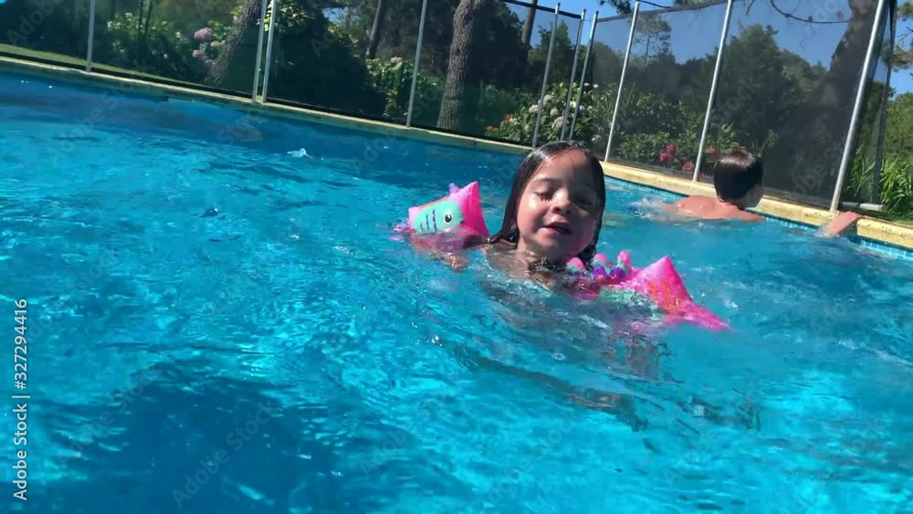 Little girl jumping into swimming pool water vídeo do Stock | Adobe Stock
