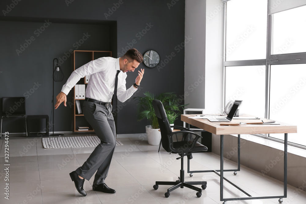 Young businessman dancing in office Stock Photo | Adobe Stock