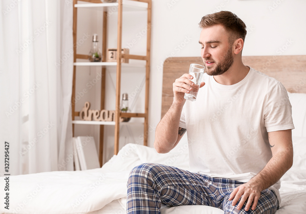 Morning of young man drinking water in bedroom Stock Photo | Adobe Stock