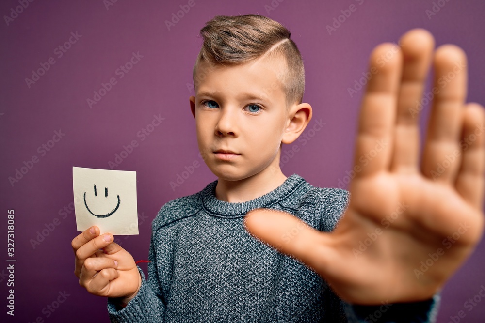 Young little caucasian kid showing smiley face on a paper note as happy ...