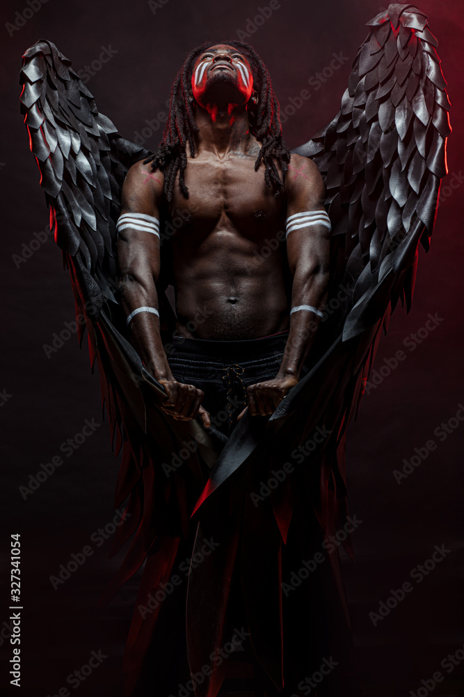 Foto de muscular african man with dreadlocks became dark angel and now ...
