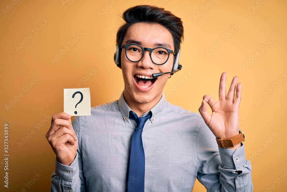 Young handsome chinese call center agent man holding paper with ...