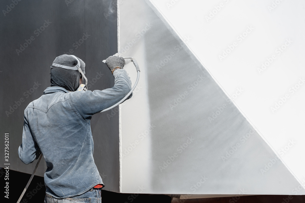 Airless Spray Painting, Worker painting on steel wall surface by ...