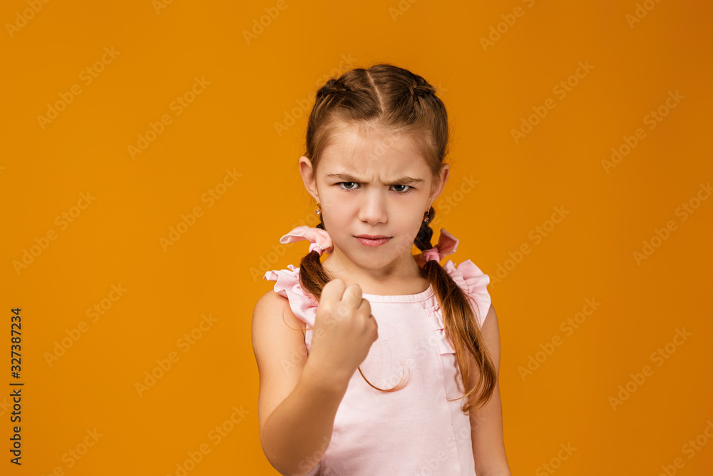 angry little child girl in dress raising fist frustrated and furious ...