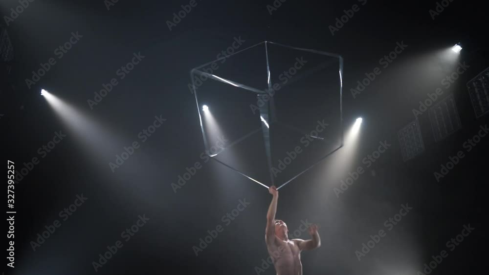 circus male muscular performer making tricks with juggling cube props ...