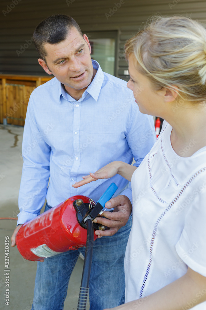 woman learning to use the fire extinguisher Stock Photo | Adobe Stock