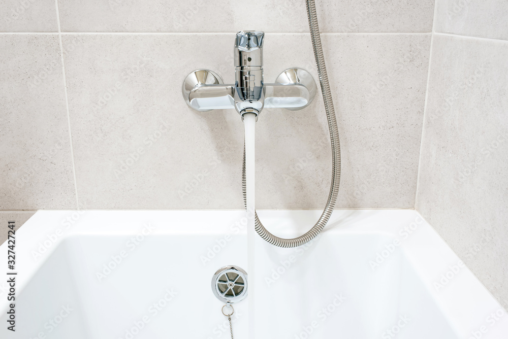 faucet with water flow view from the bathroom. interior of a modern ...