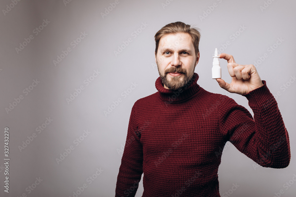 Happy bearded man in claret-colored sweater posing in studio with grey ...