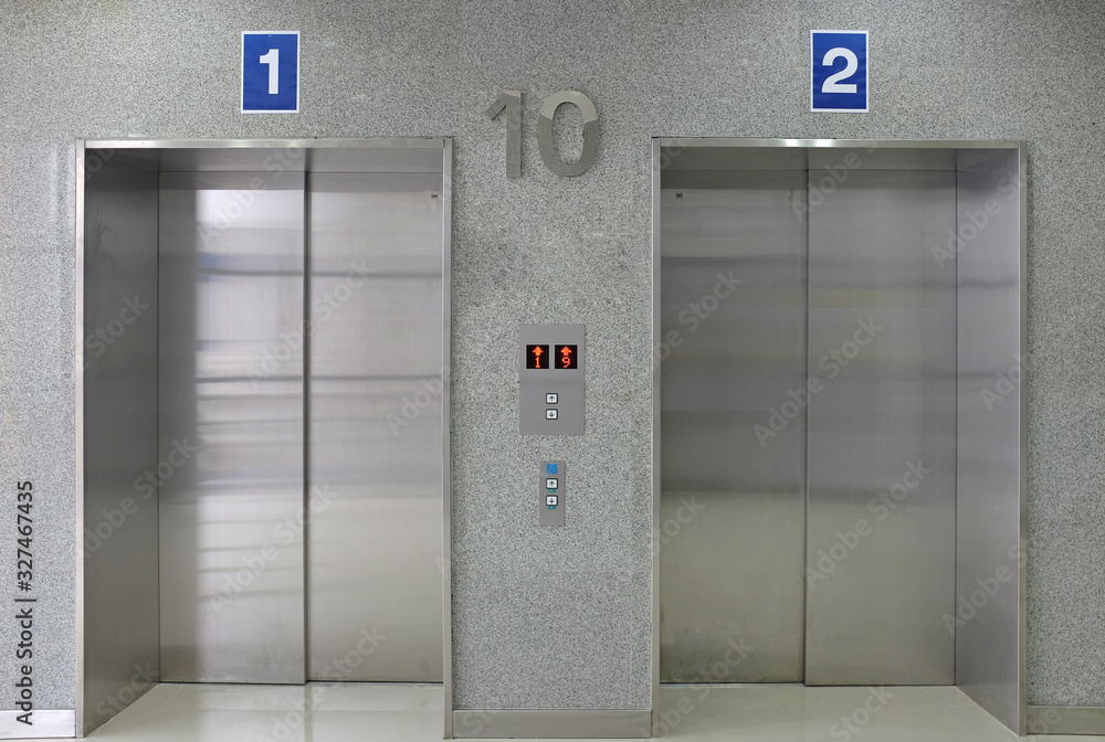 Closed metal elevator doors of office building. Stock Photo | Adobe Stock