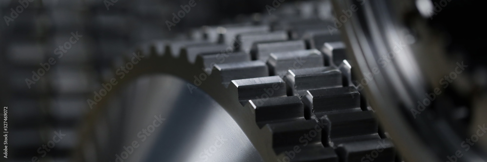 Close-up of metallic cogs nested in modern factories for rapid and ...