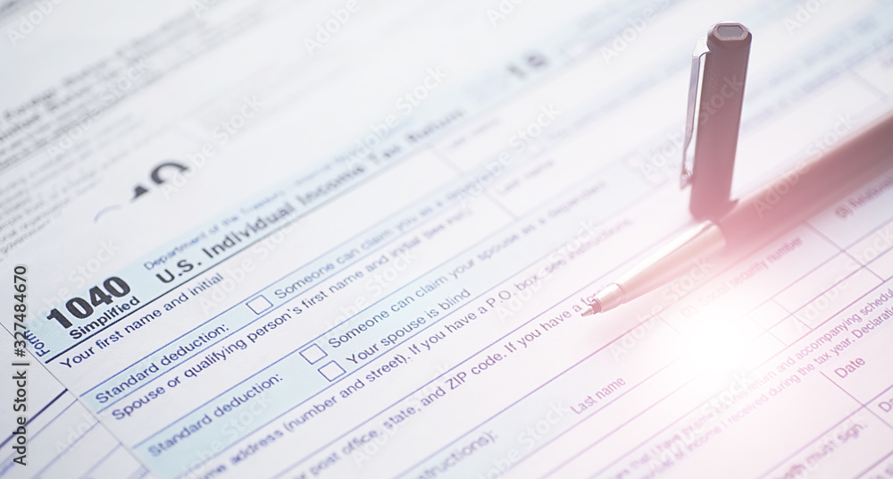 Annual tax reporting. Tax form on the table. Financial statements for ...