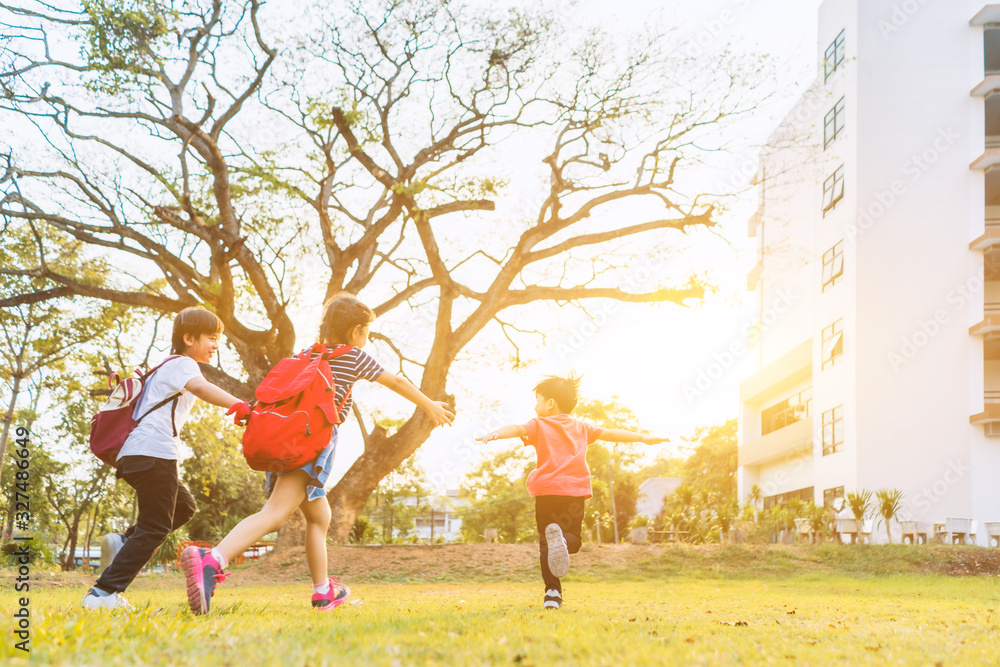 Blurry image of Children running happily in the lawn. Happy children ...