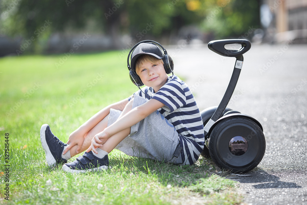 Cute child driving electric gadget. Boy riding a segway. Active child ...