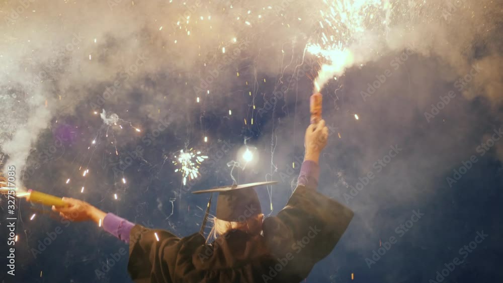 An emotional college graduate in a mantle and a graduation cap with two ...