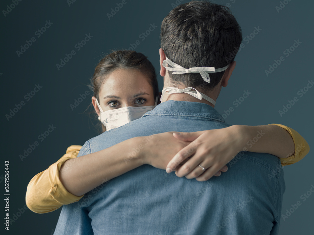 Millennials couple wearing a protective mask and hugging Stock Photo | Adobe Stock