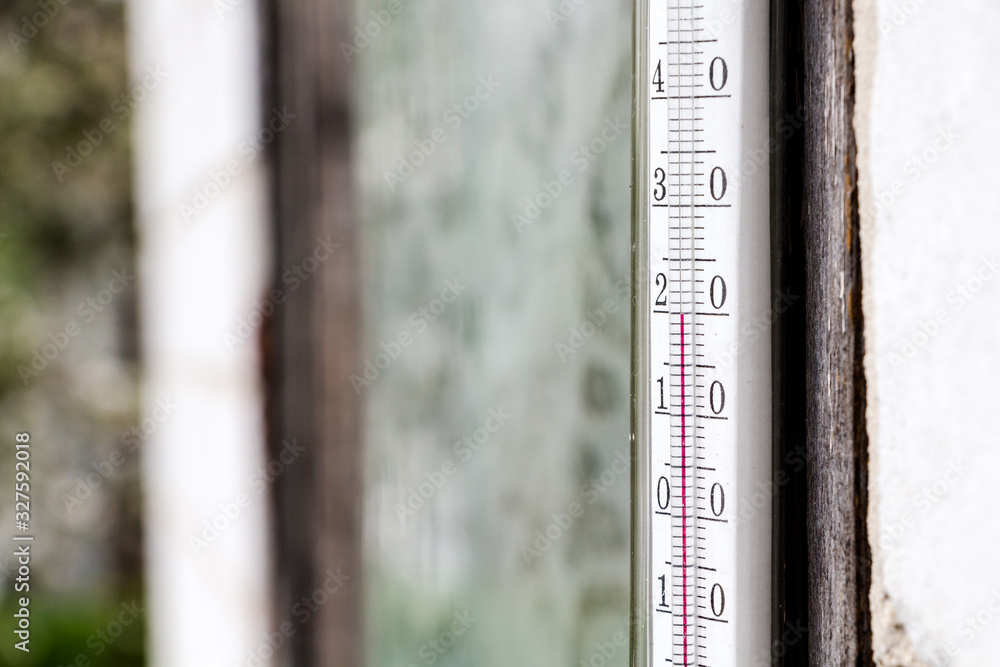 old glass thermometer for measuring outdoor temperature, showing twenty ...
