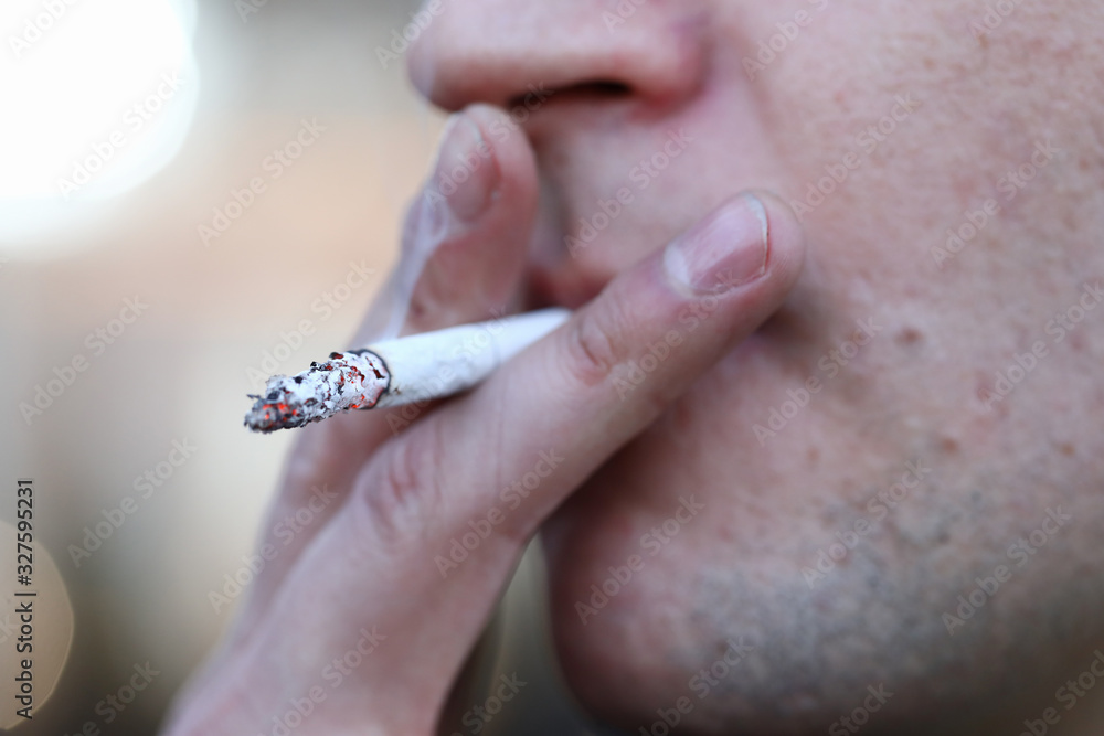 Close up man smoking cigarette, addictive habit. Harm smoking on human ...