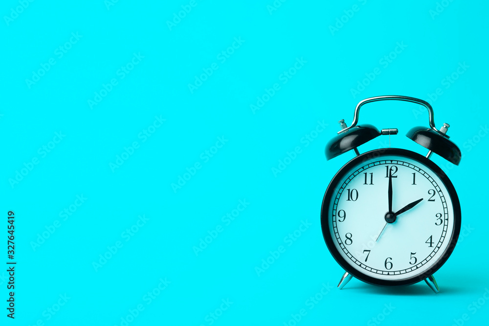 Time background concept. Vintage classic alarm clock on blue empty ...