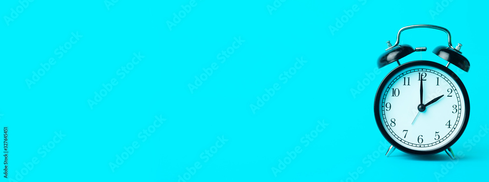 Time background concept. Vintage classic alarm clock on blue empty ...