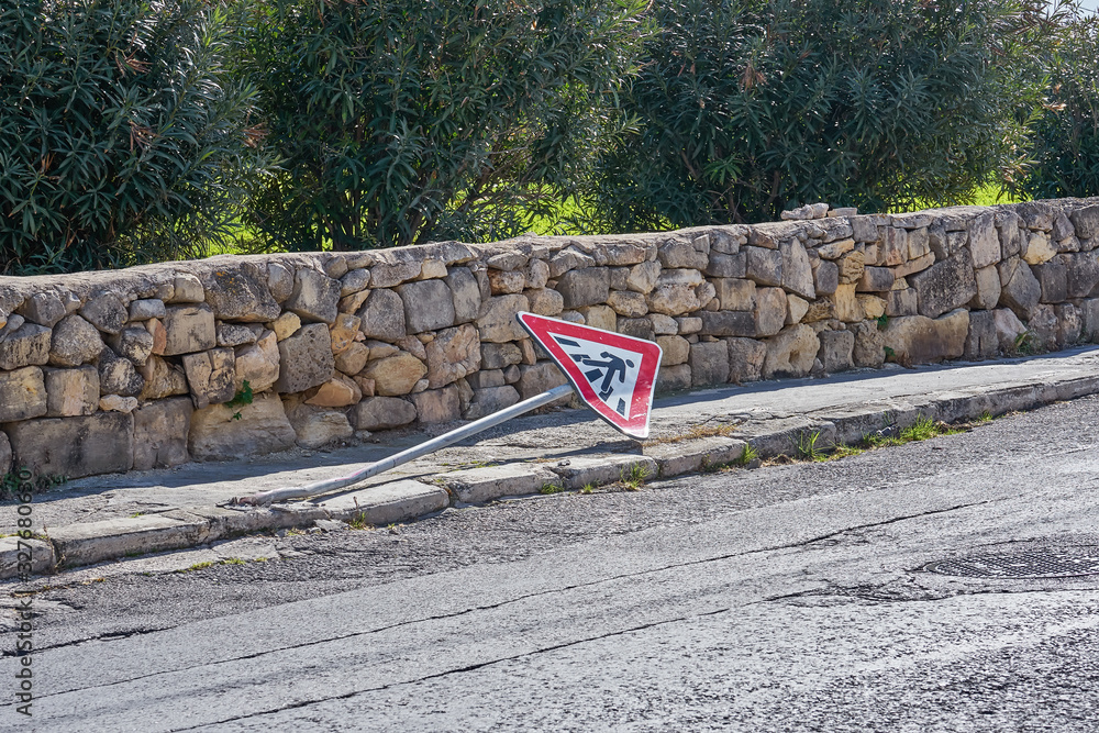 Broken road sign with symbol of pedestrian and pedestrian crossing ...