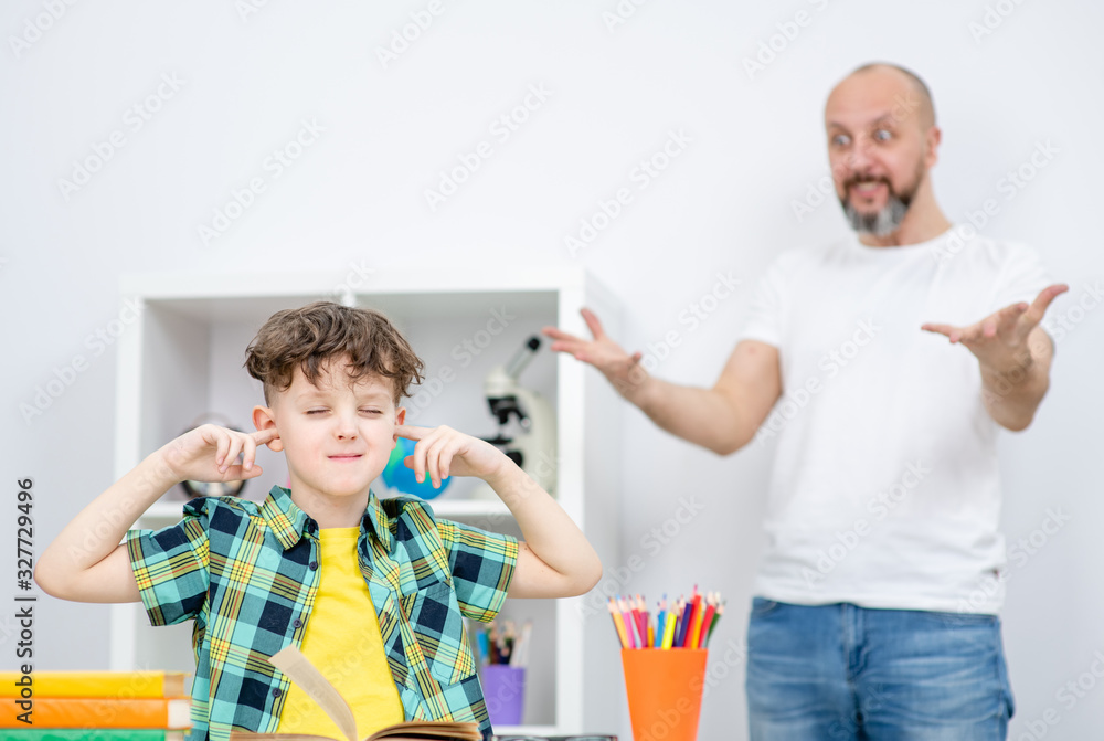 Angry father scolds his son for poor study Stock Photo | Adobe Stock