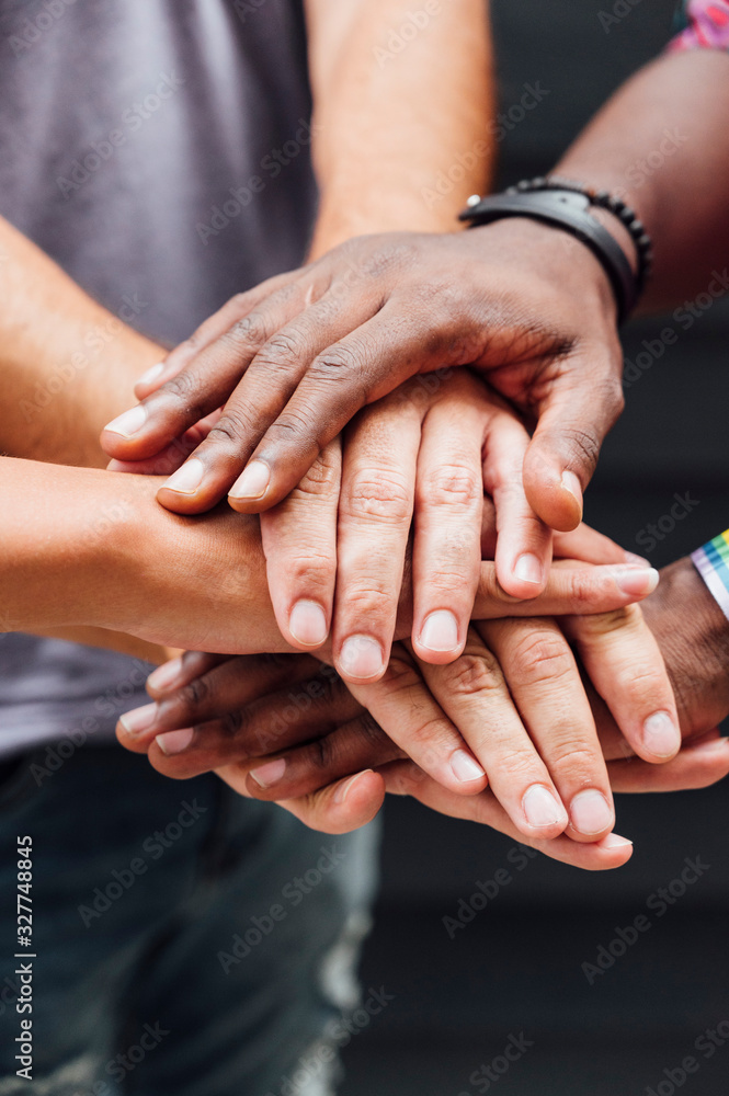 Different people putting hands in stack Stock Photo | Adobe Stock