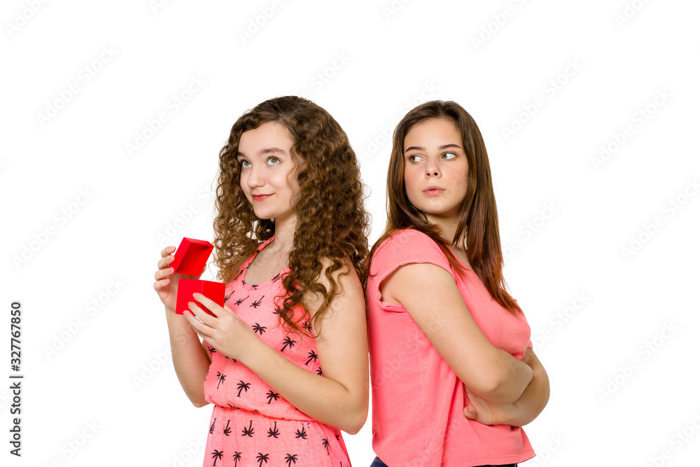 Beautiful teenager girl received a gift, and the other girl looks ...