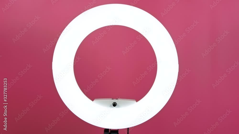 Turning on and turning off white led ring lamp in the studio. Circle ...
