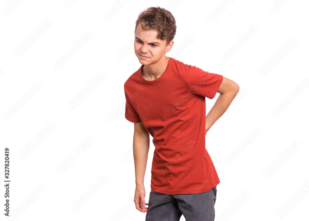 Portrait of unhappy teen boy suffering from backache, isolated on white ...