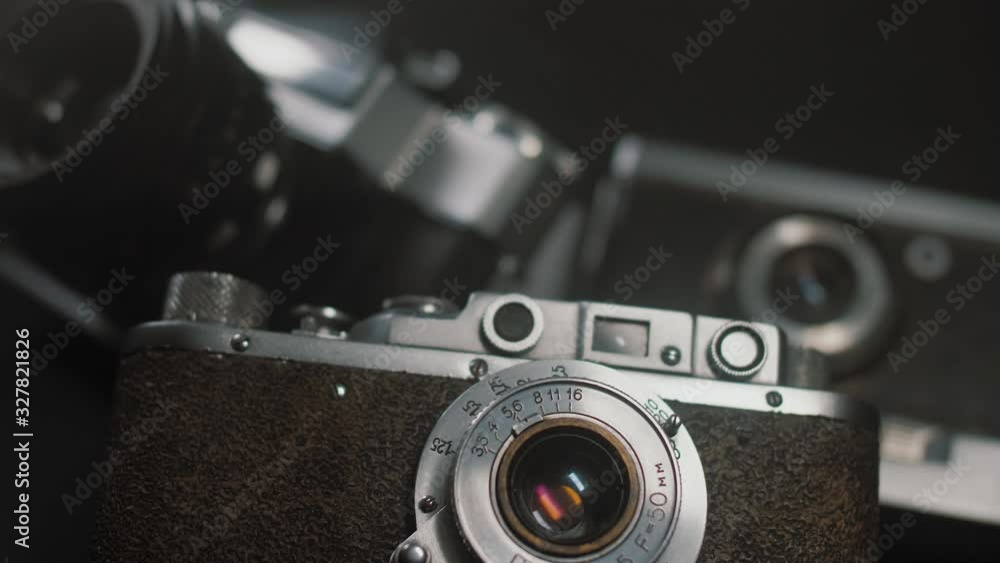Vintage film photo camera lies in background of other old analog ...