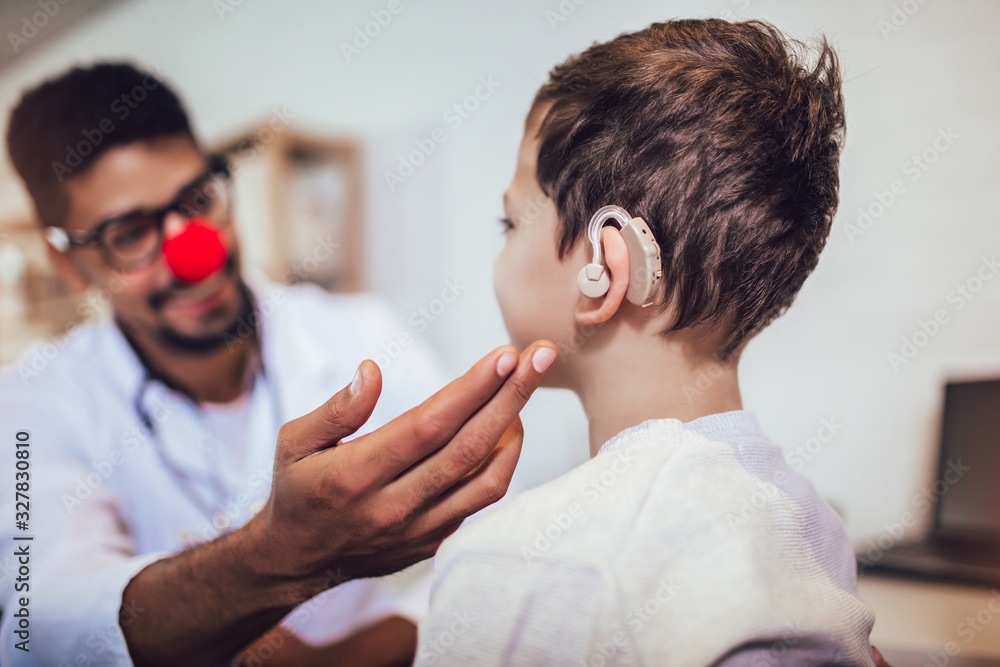 Smiling deaf boy with ear implant at doctor's office. Stock Photo ...