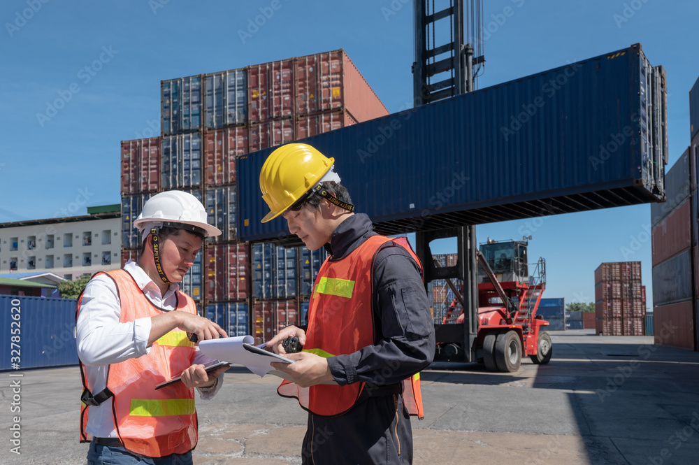 Foreman control loading containers box from cargo freight ship for ...