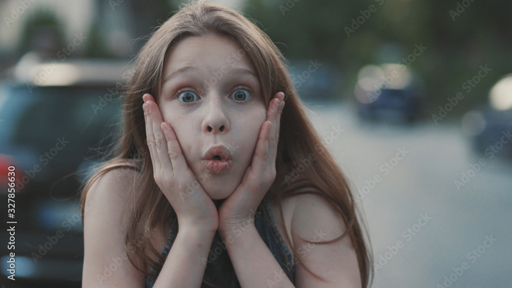 Shocked little girl looking at camera. Big eyes. Beautiful female ...