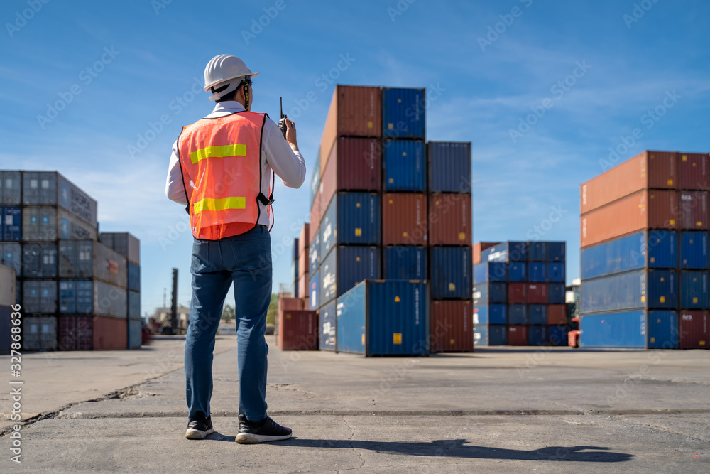 Logistics engineer control at the port, loading containers for trucks ...