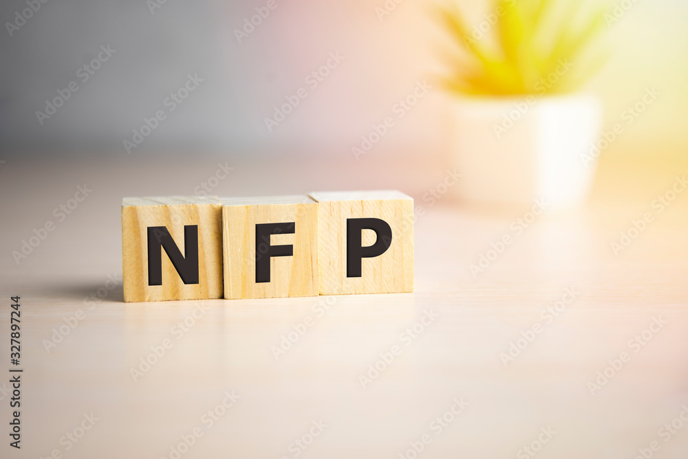 NFP - acronym from wooden blocks with letters, abbreviation NFP Nonfarm ...