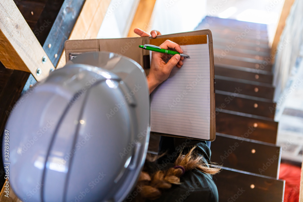 Stockfoto top view of construction inspector woman sits on the stairs ...