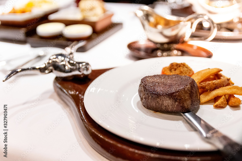 Medium rare juicy filet mingon beef steak served on white, warm plate ...
